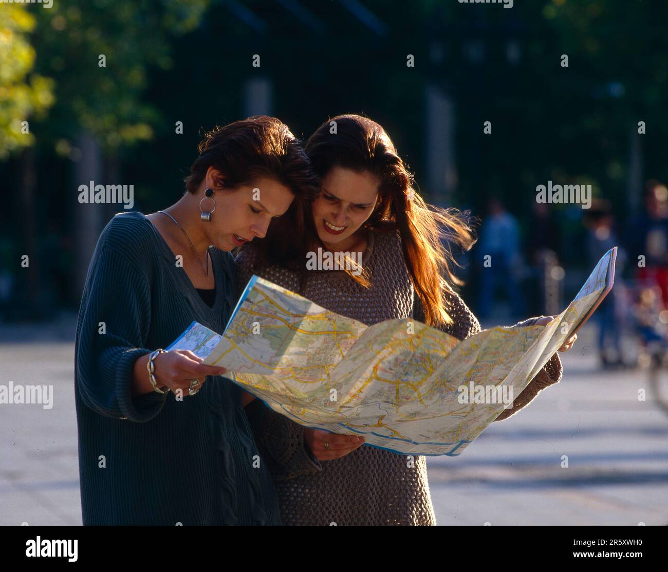 Two young woman with a city map Stock Photo - Alamy