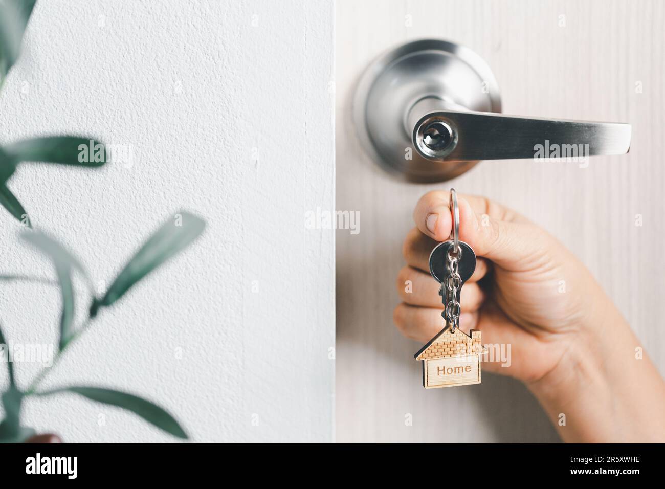 close up key on the door with morning light, personal loan concept ...