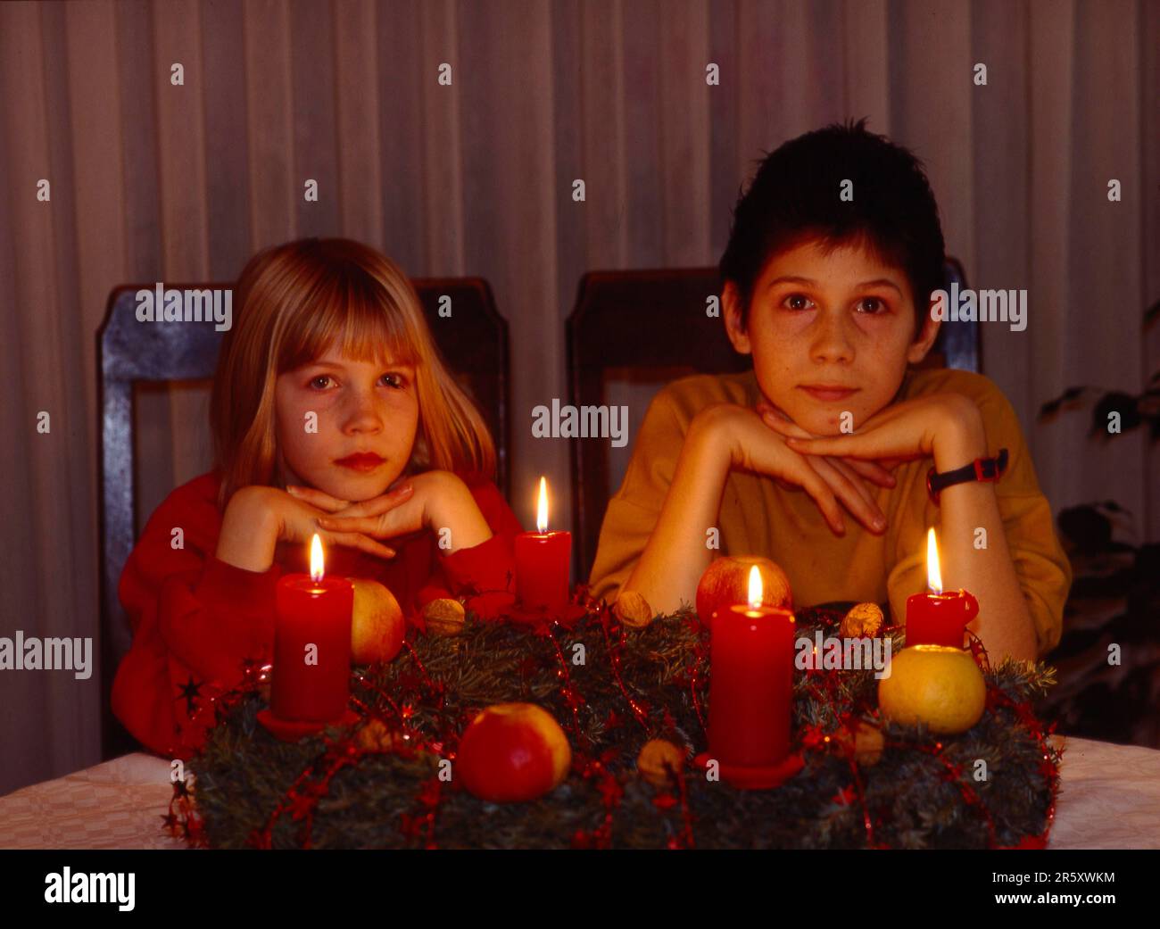 2 two children sit in the Advent wreath, 4 four burning candles, yule ...