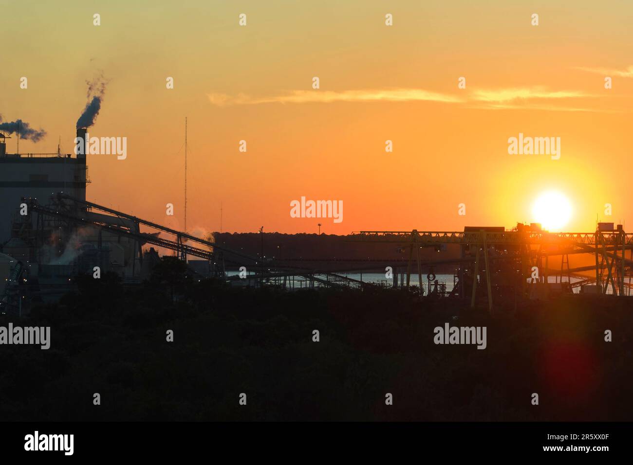 Aerial view of wood processing factory with smoke from production ...