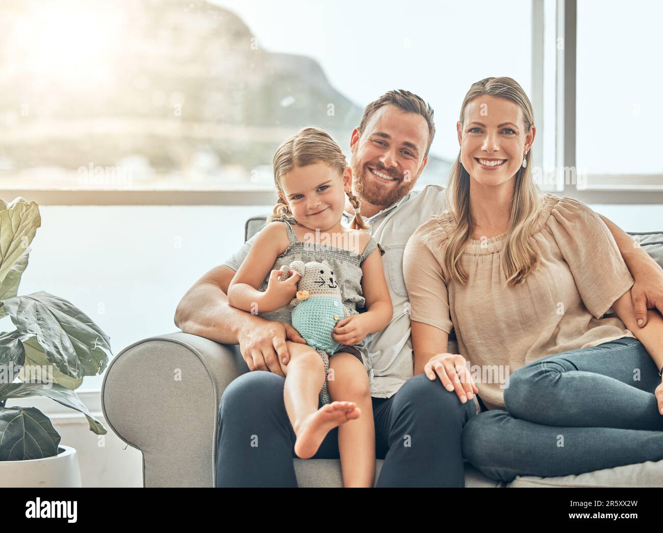 Portrait of mother, father and child on sofa in living room for bonding ...