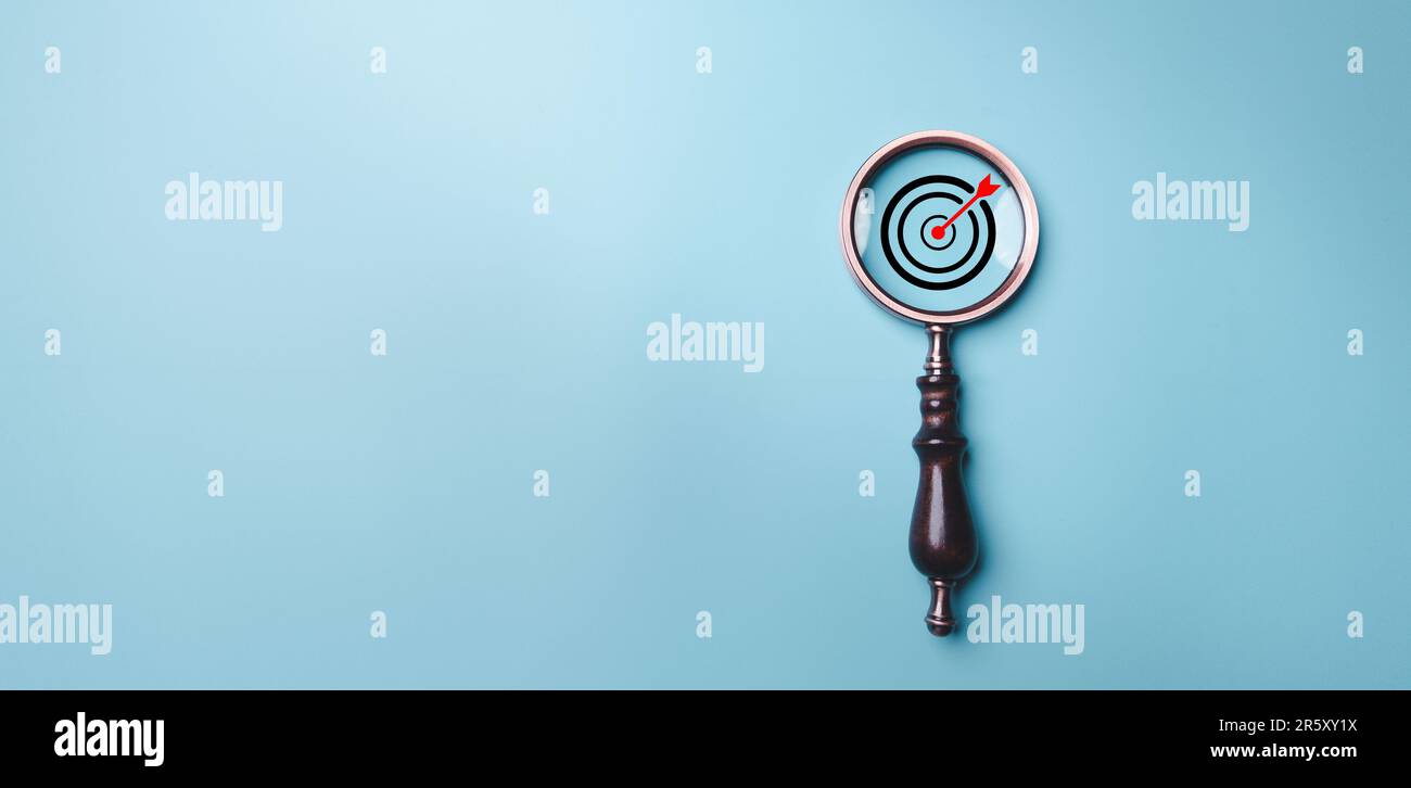 Target board inside vintage magnifying glass for focus business ...