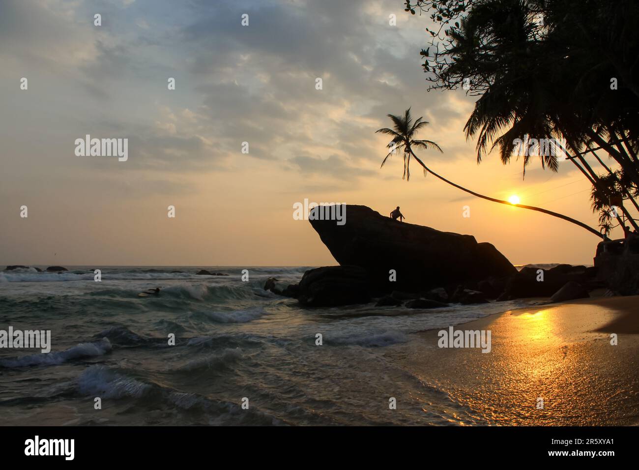Sri Lanka sunset at Dalawella Beach, beautiful sunset sky, rocks and ...