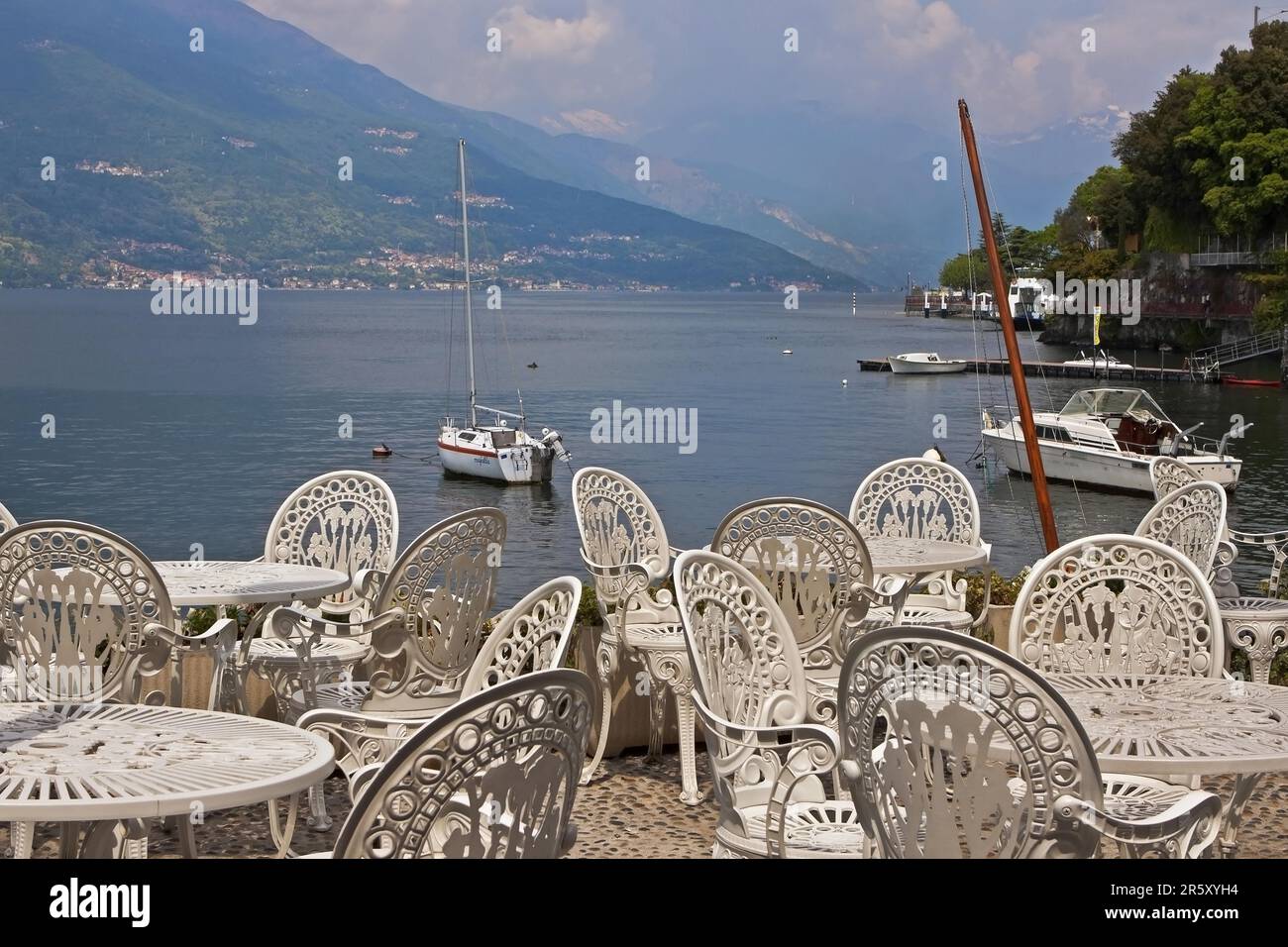 Tables and chairs, lakeside cafe, Varenna, Lake Como, province of Lecco ...