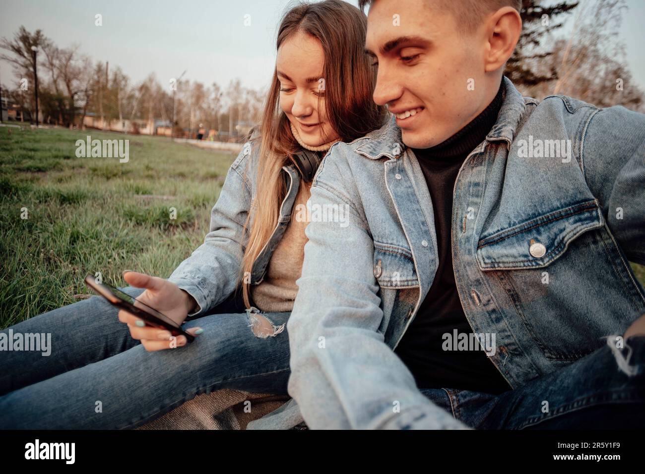 Woman smiles using smartphone hi-res stock photography and images - Alamy