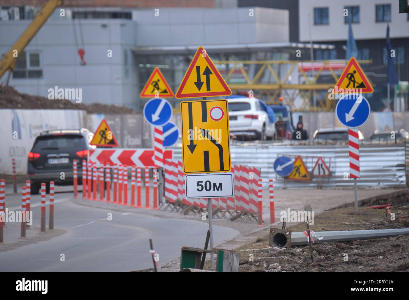 Roadworks warning traffic signs of construction work on city street and ...