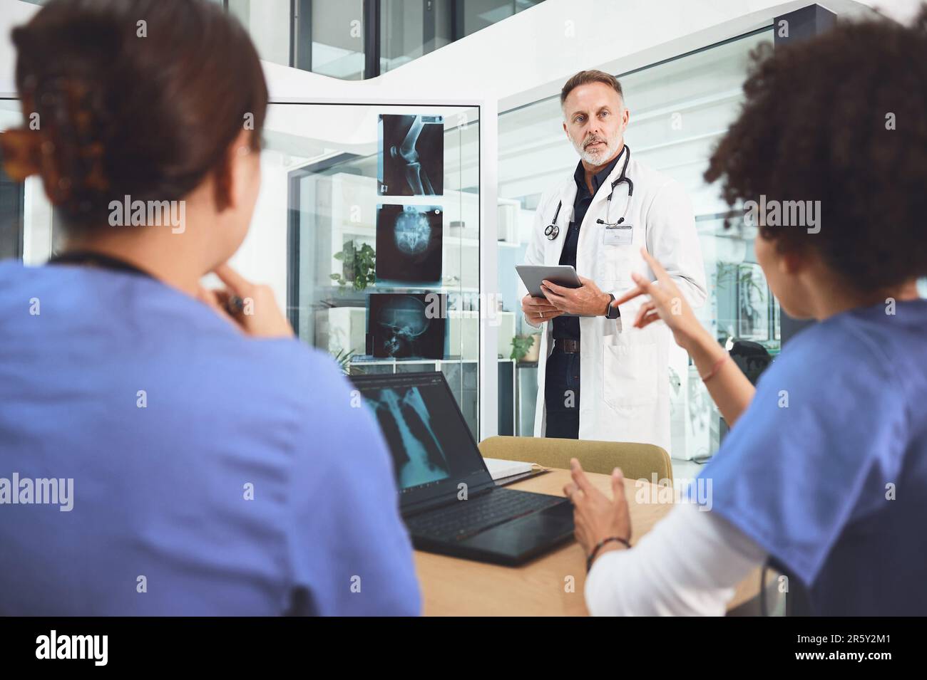 Putting their heads together to assess the problem. a mature doctor ...
