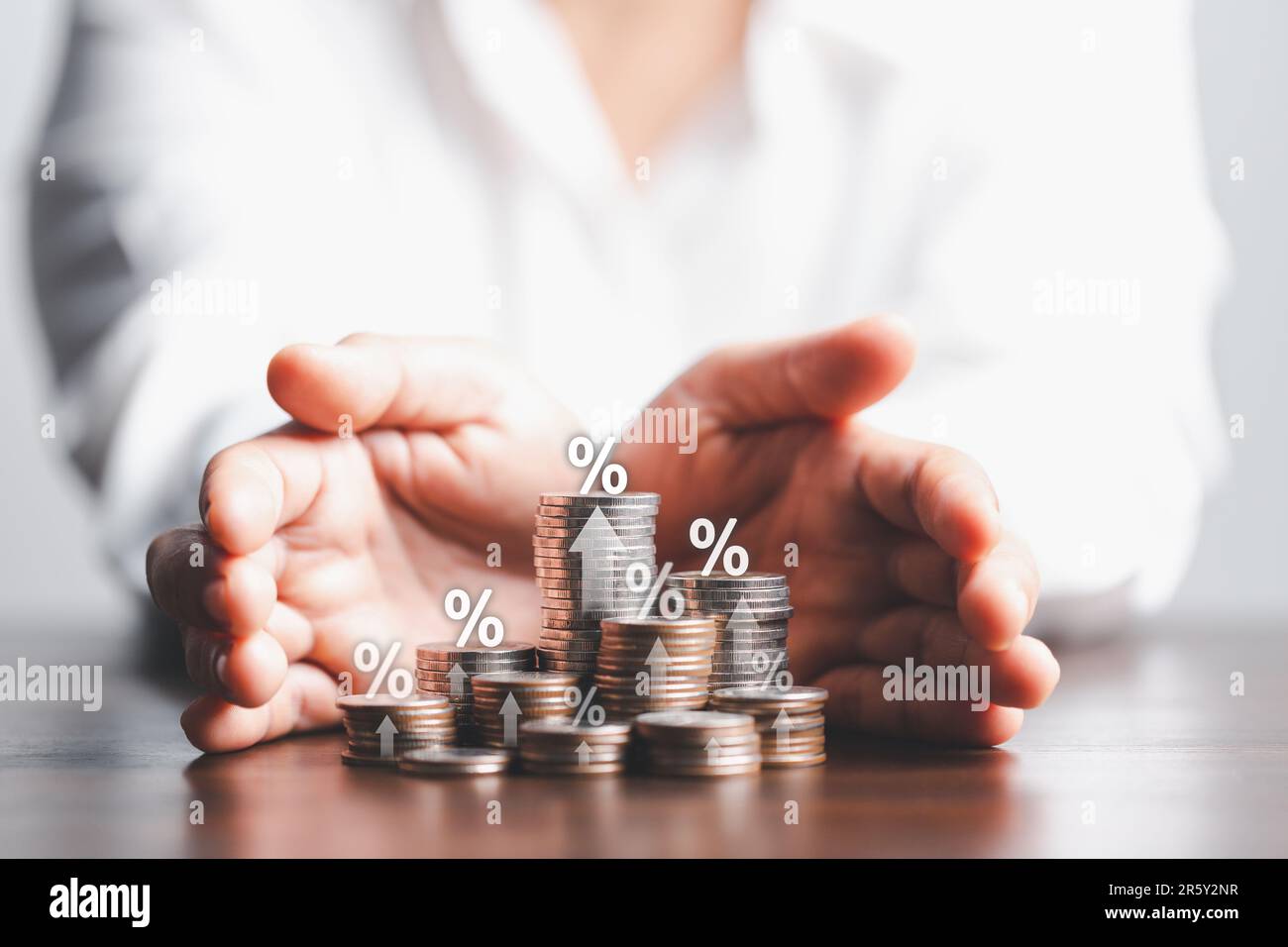 Businesswoman hand giving heap of coins money with up arrow and ...