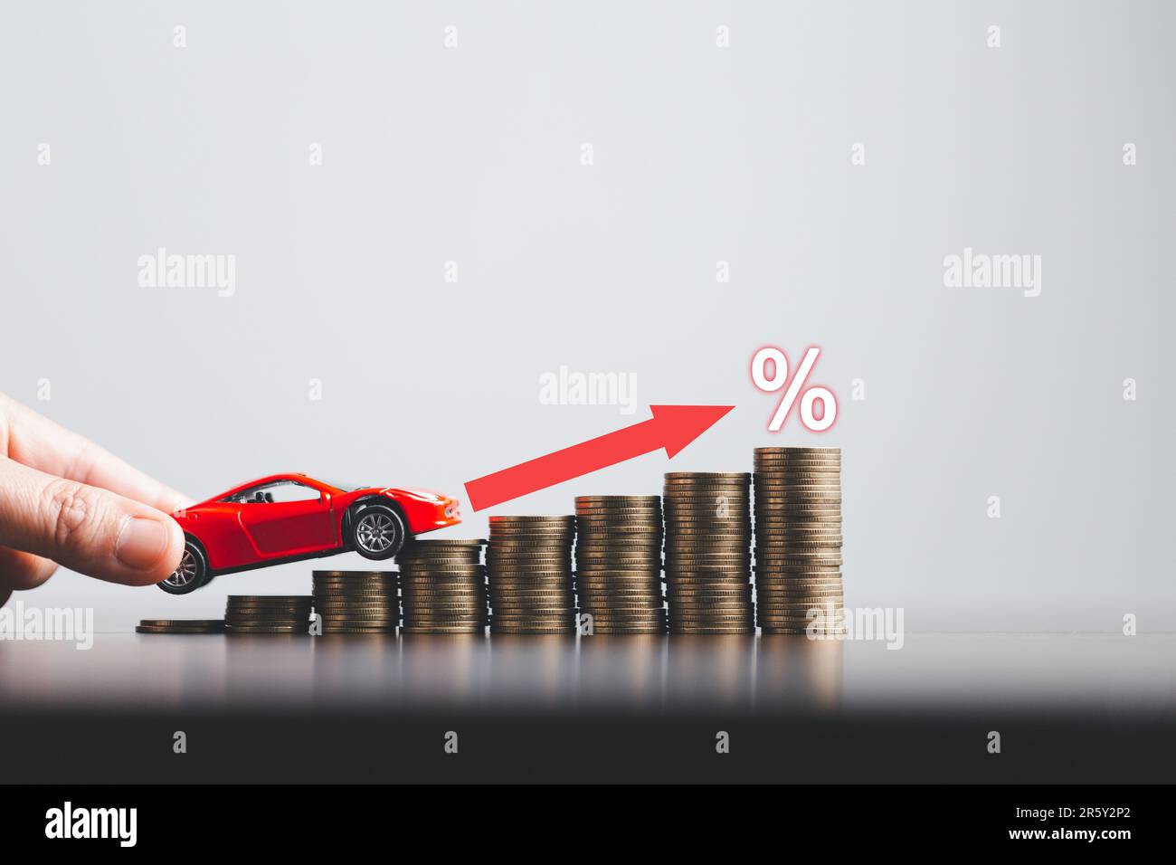 Stacks of coins and red car with percentage symbol for increasing ...