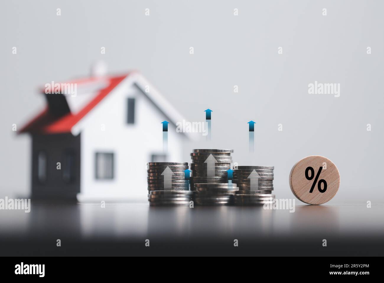 Stacks of coins and model house with percentage symbol for increasing ...