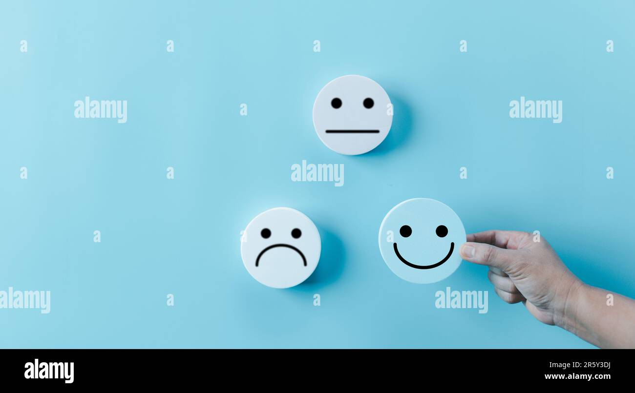 Woman hand holding happy face smile face icon on round blue object ...
