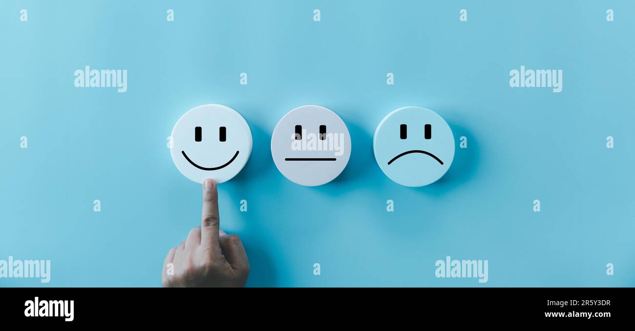 Woman hand touching happy face smile face icon on round blue object ...