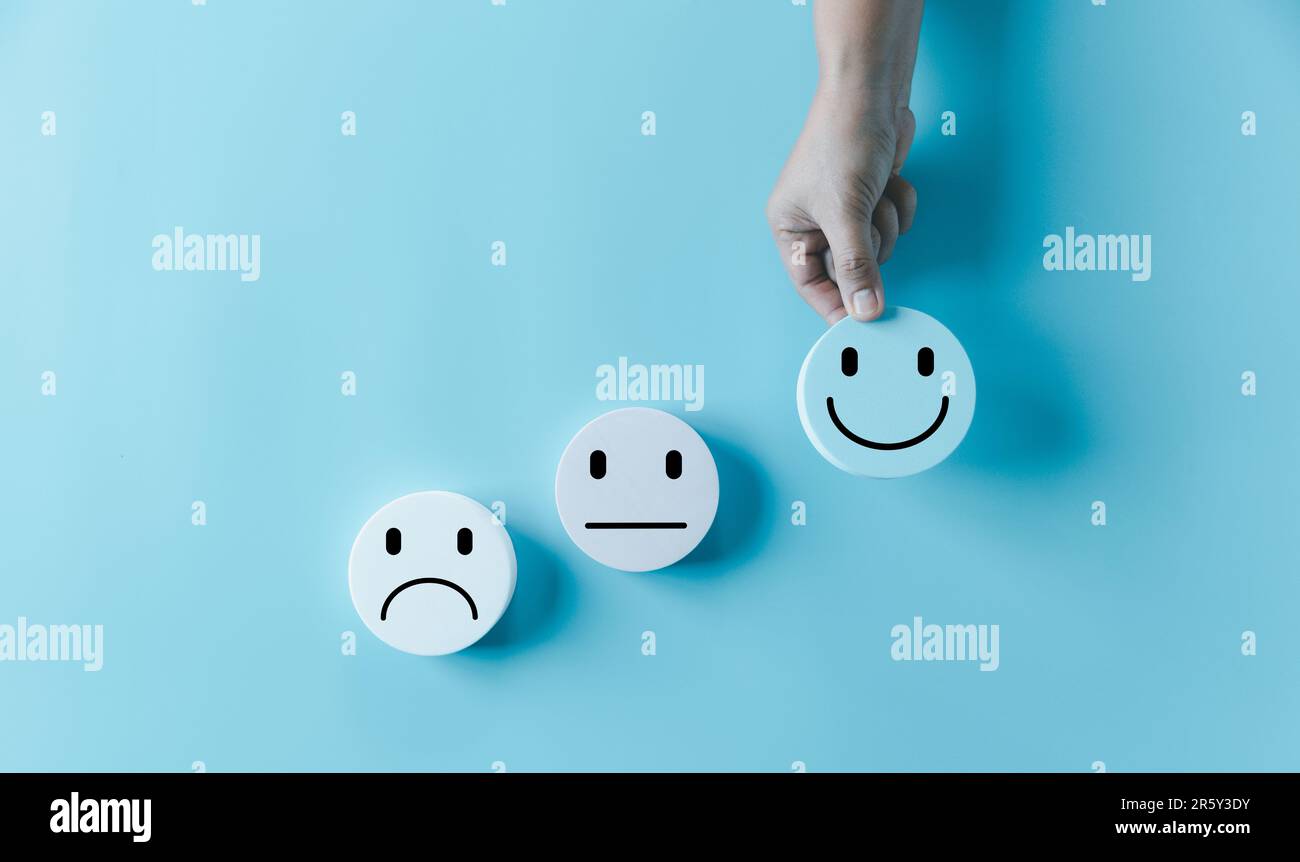 Woman hand holding happy face smile face icon on round blue object ...