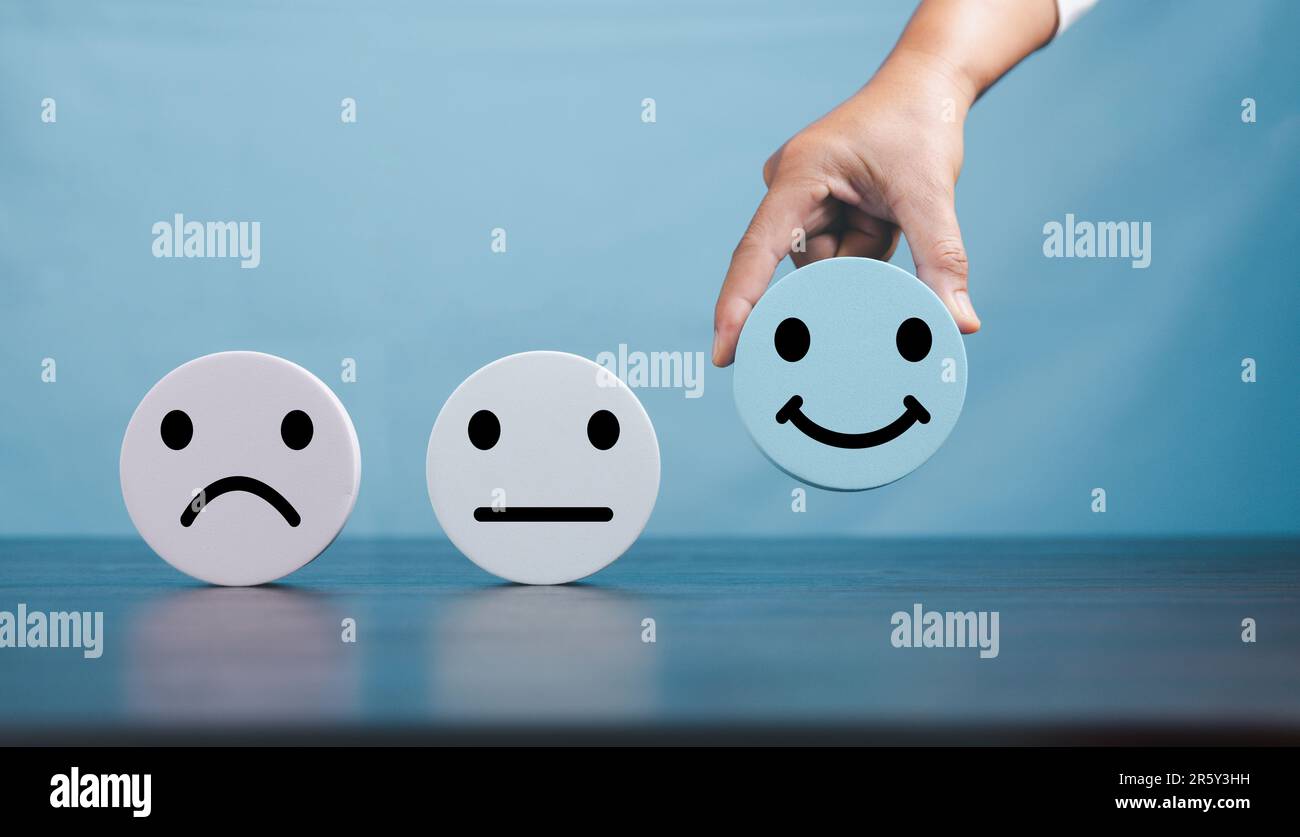 Woman hand holding happy face smile face icon on round blue object ...
