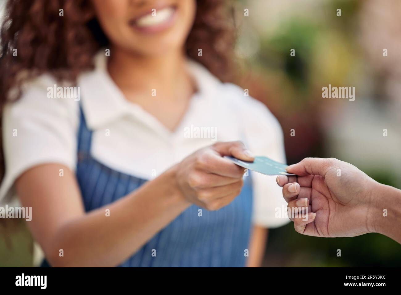 Woman waiter, hand and credit card payment at a shop with barista and ...