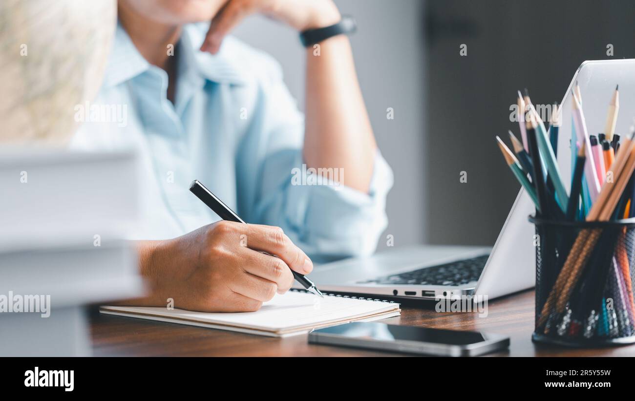 Education concept. Close up of female student make notes hand write in ...