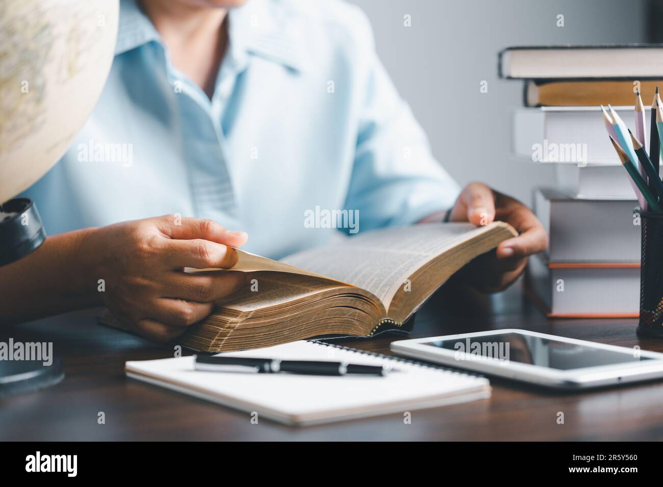 Female student study in the school library. She using laptop and ...