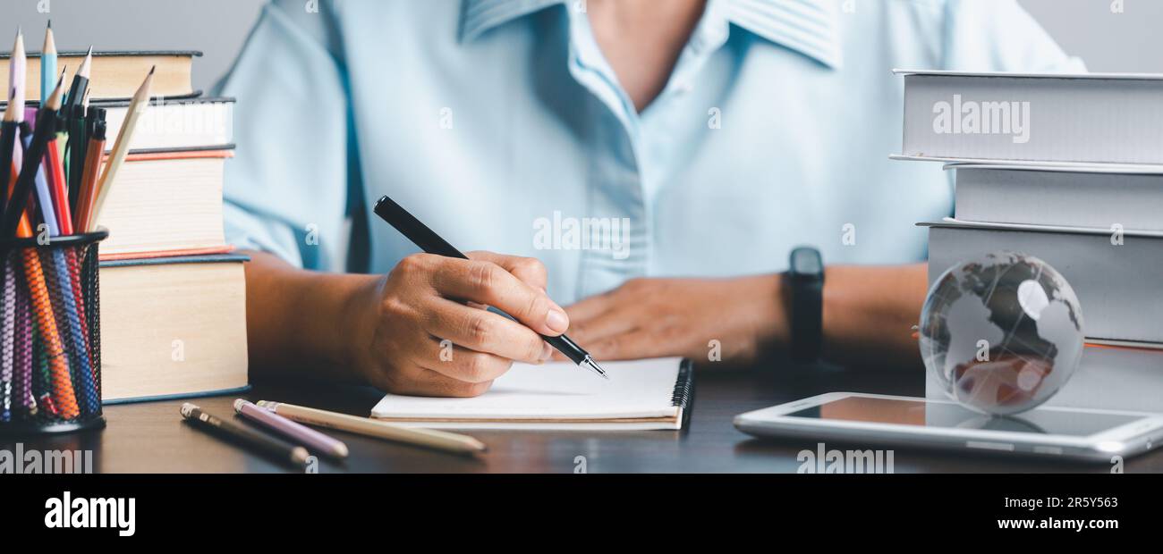 Education concept. Close up of female student make notes hand write in ...