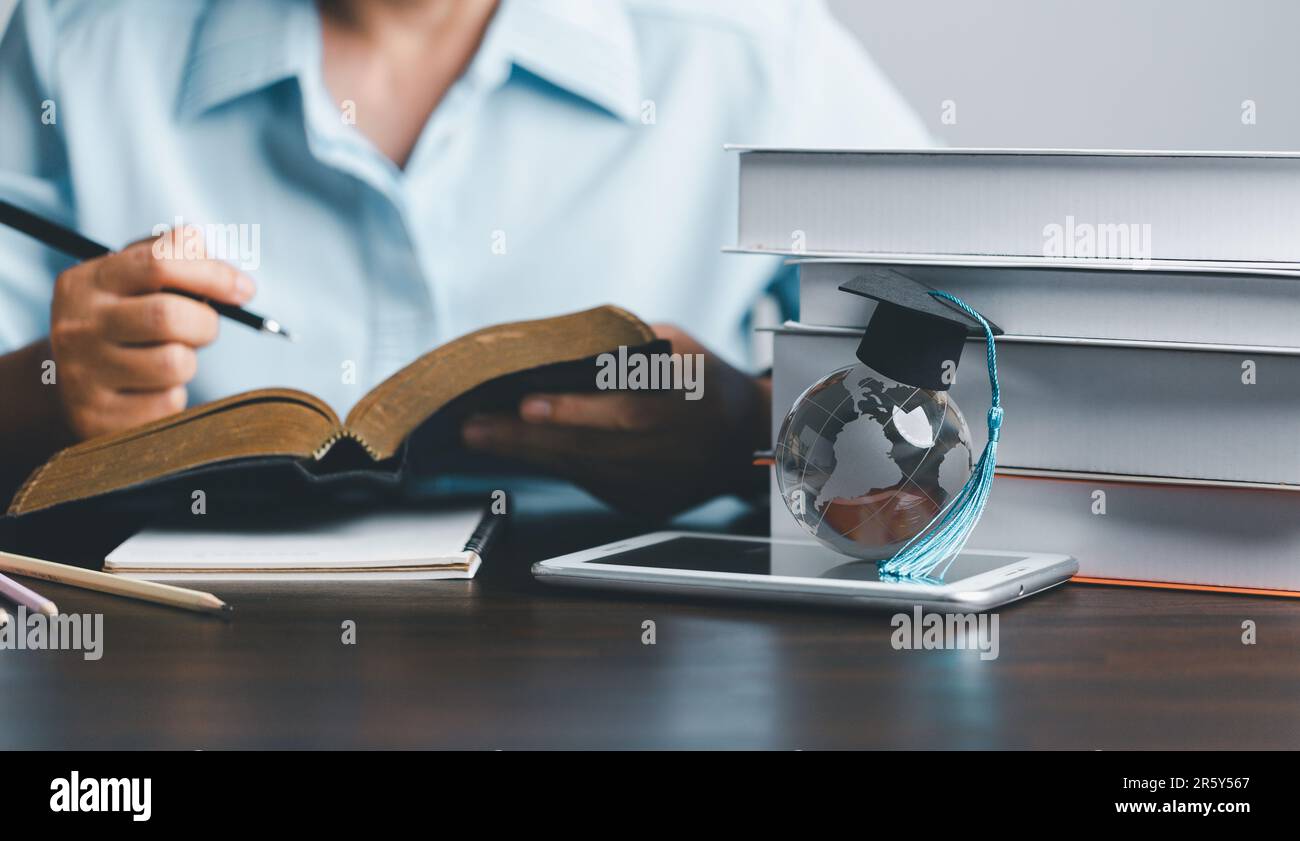 Female student study in the school library. She using laptop and ...