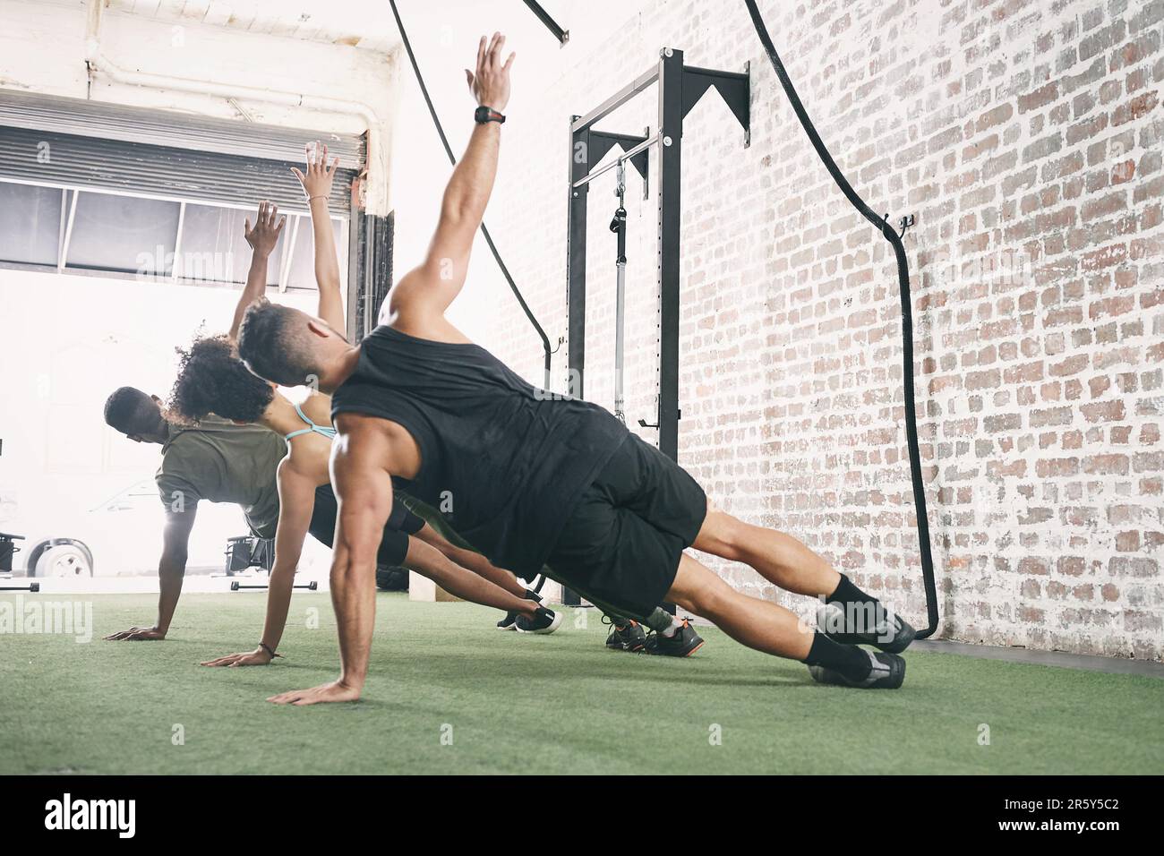 Improve your body balance. a fitness group doing the side plank ...