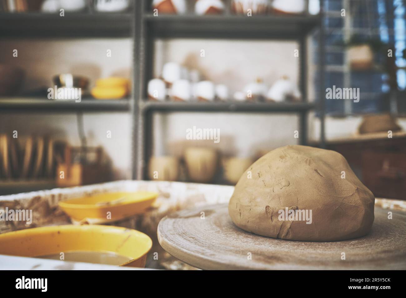 Ready, set, create. a lump of clay on a pottery wheel in a ceramic ...