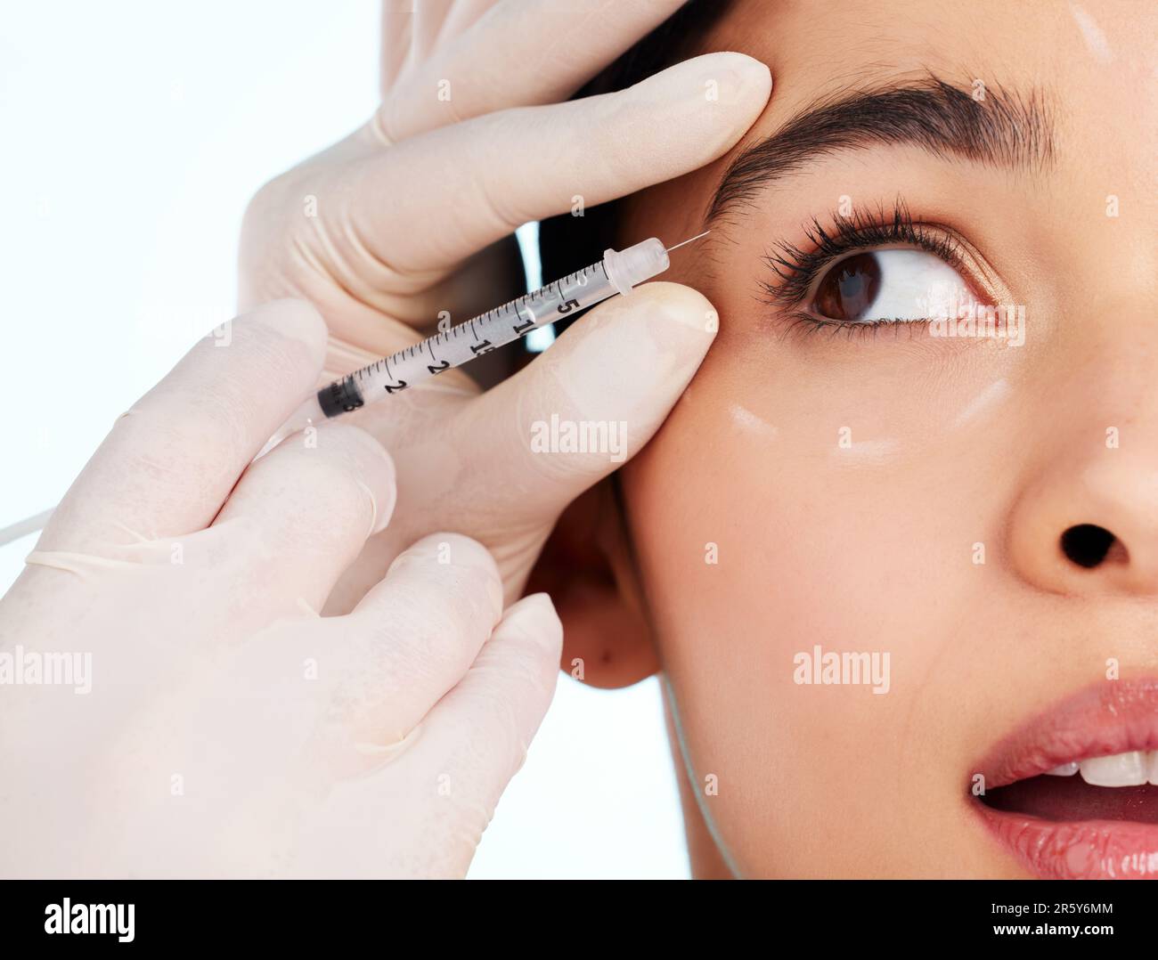 Woman, skincare and face injection for plastic surgery in studio ...