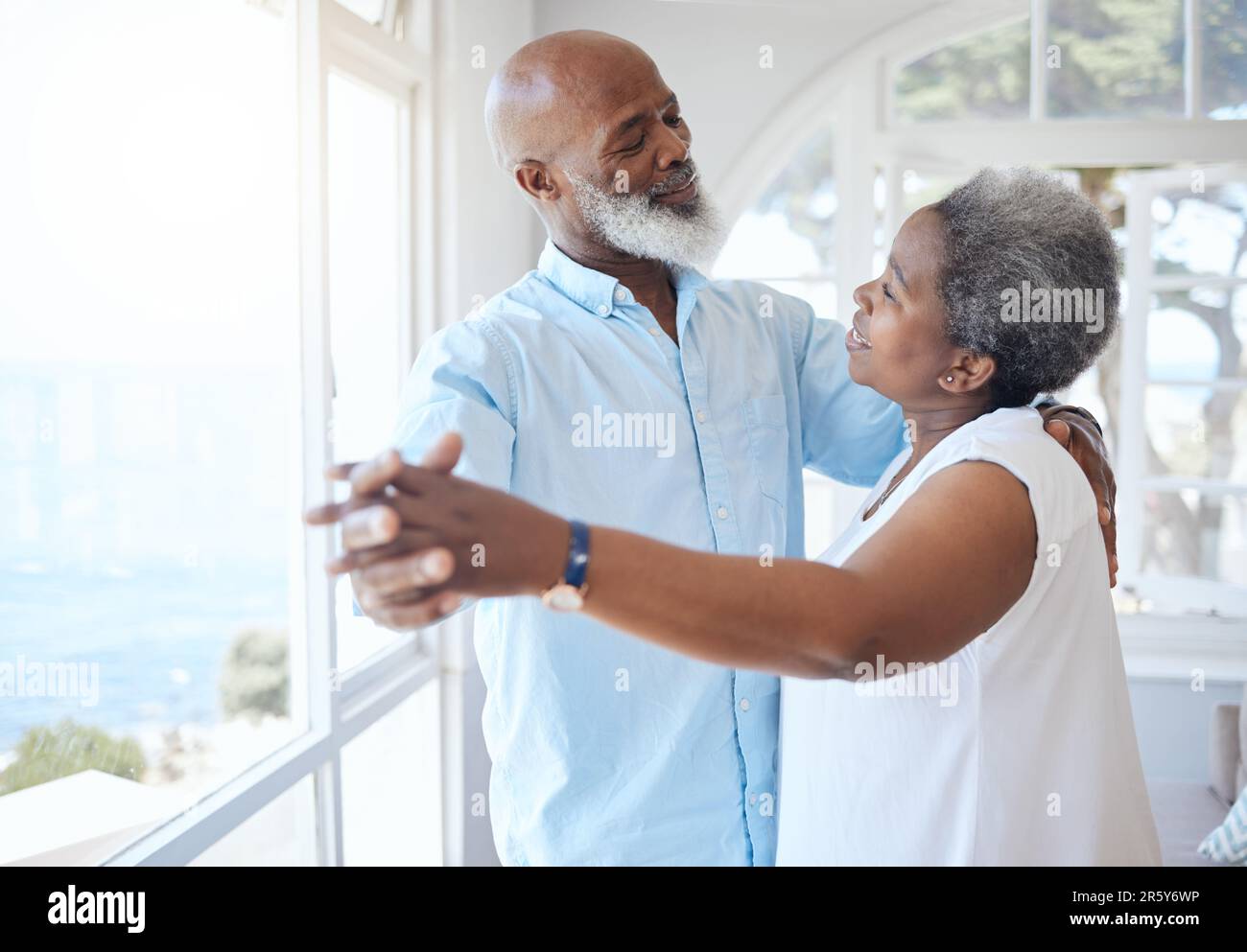 Black couple, dancing and together in senior home with love, care and ...