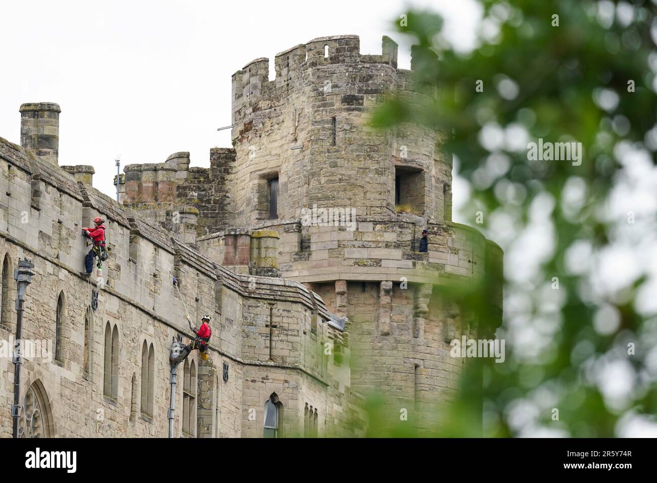 Cleaners abseil down the walls of Warwick Castle's south front, as they carry out the landmark's ...