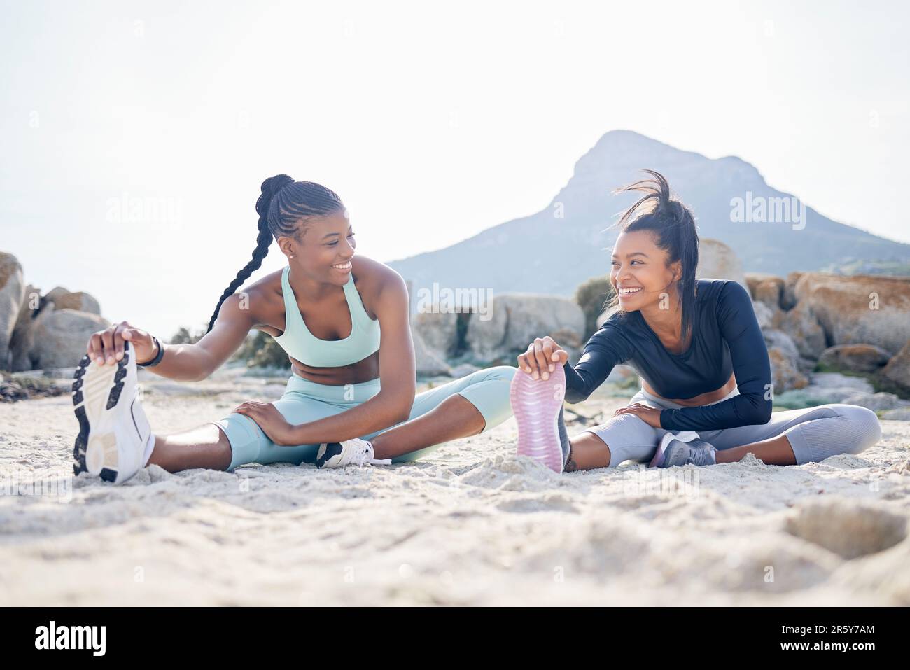 Stretching, running and friends with women at beach for fitness, yoga ...