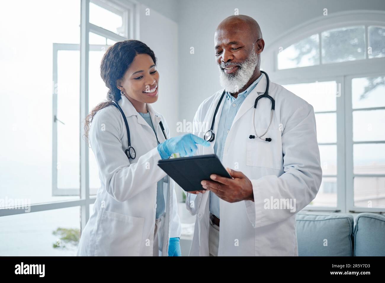 African doctors, teamwork and talk with tablet, data analysis or ...