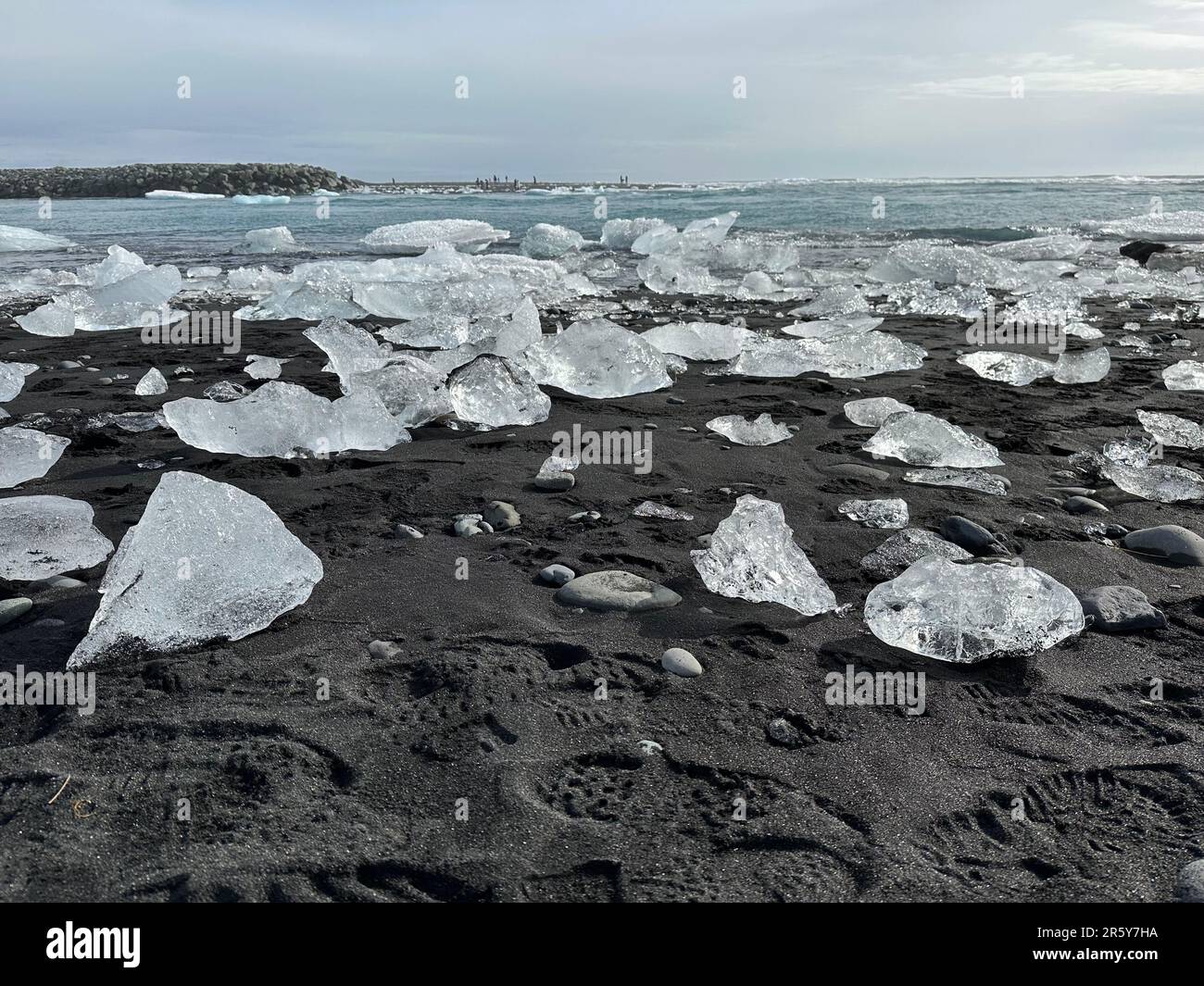 Diamond Beach, Iceland. 12th Apr, 2023. Pieces of ice lie in the black ...