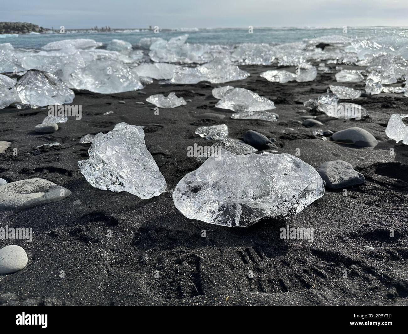 Diamond Beach, Iceland. 12th Apr, 2023. Pieces of ice lie in the black ...