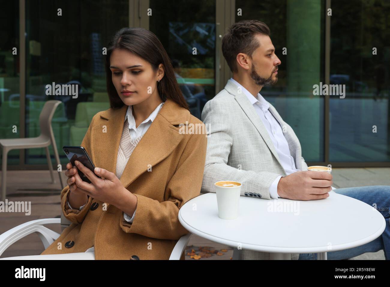 Upset arguing couple in outdoor cafe. Relationship problems Stock Photo ...