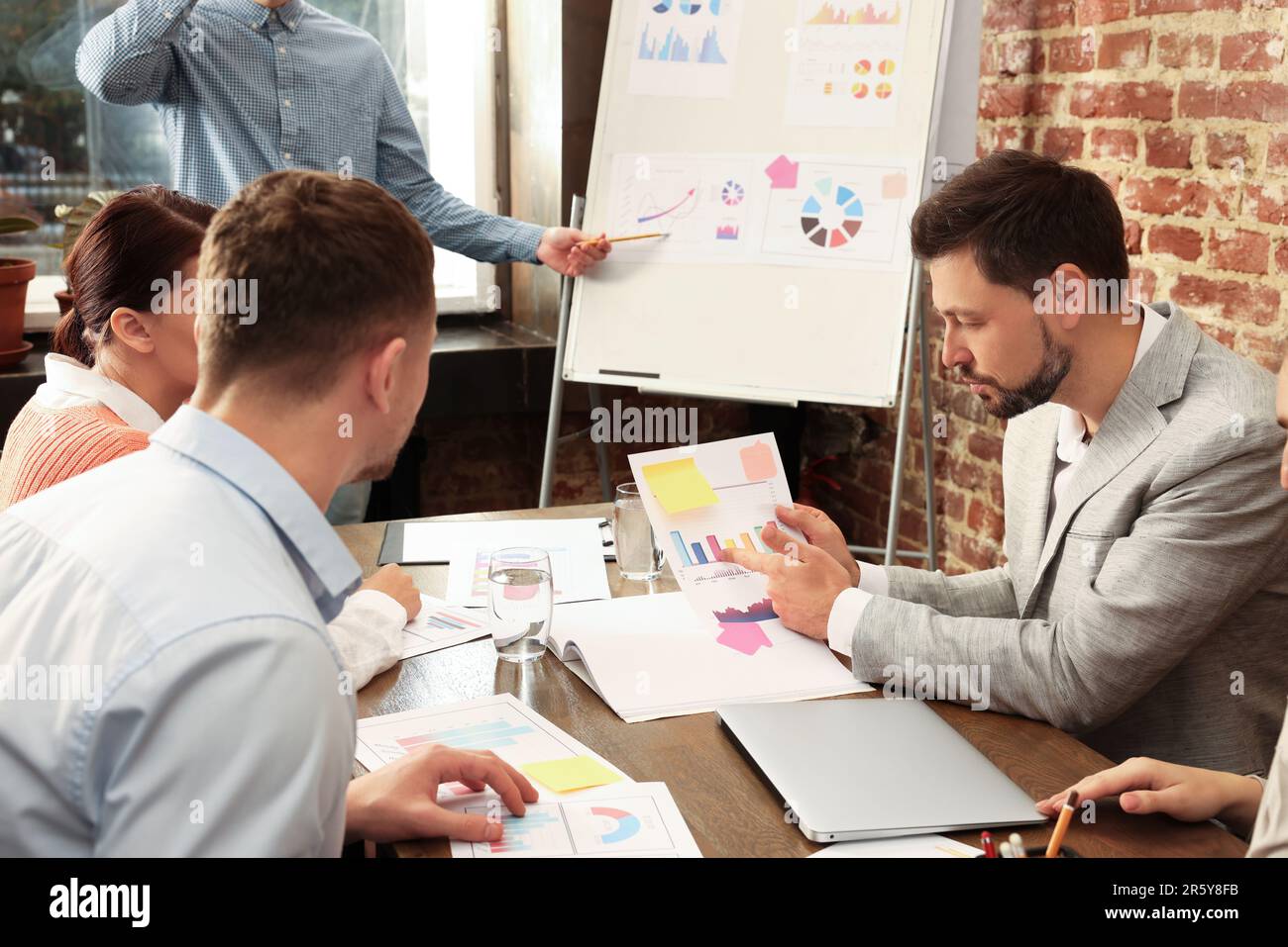 Employees having meeting in office. Team work Stock Photo - Alamy