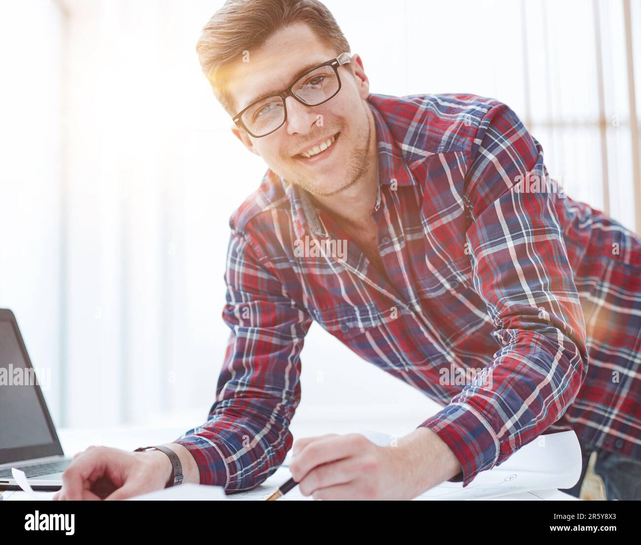 Back view of businessman sitting in front of laptop screen. Man typing ...