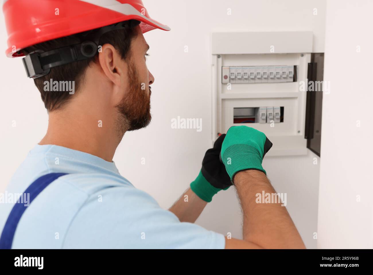 Electrician installing fuse box with screwdriver indoors Stock Photo ... Electrician installing fuse box with screwdriver indoors Stock Photo ...
