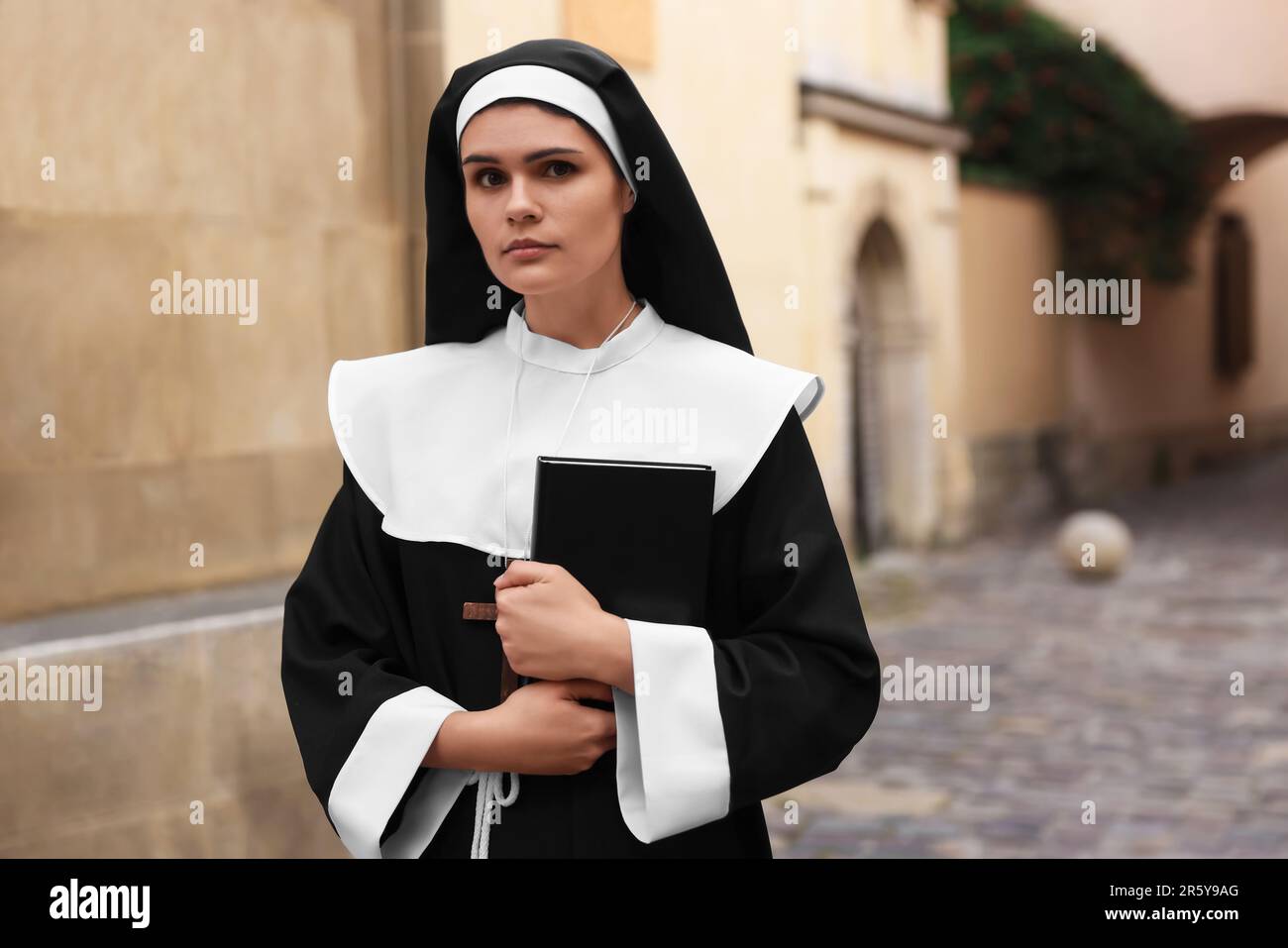 Portrait young nun bible hi-res stock photography and images - Alamy