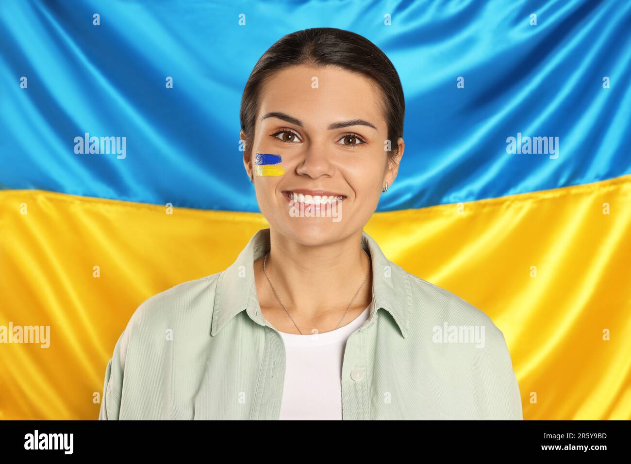Young woman with face paint near Ukrainian flag Stock Photo - Alamy