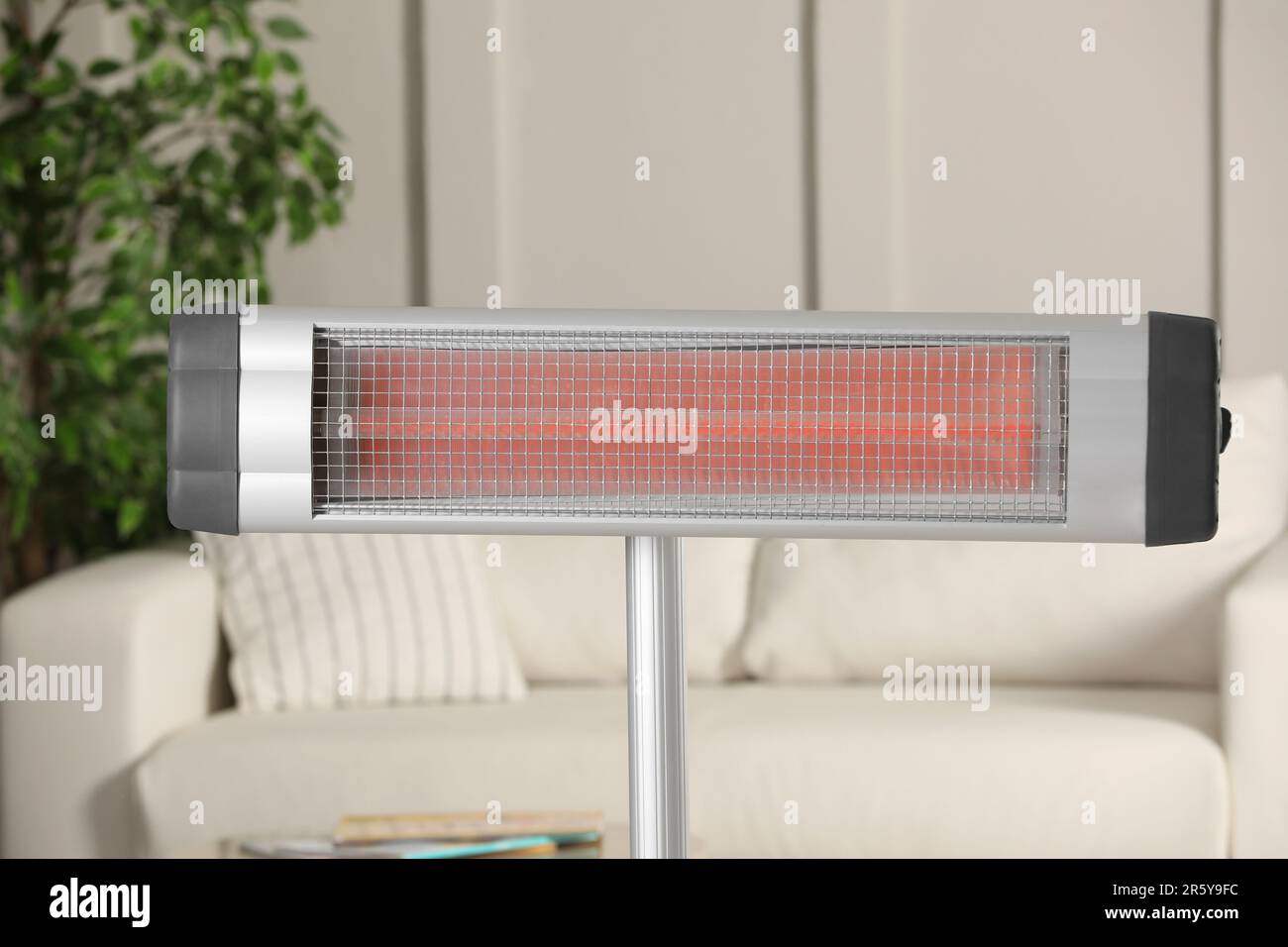 Modern electric infrared heater in cozy room Stock Photo - Alamy