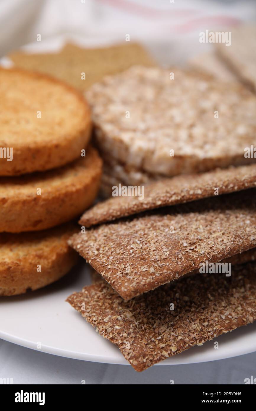 Rye crispbreads, rice cakes and rusks on plate, closeup Stock Photo - Alamy