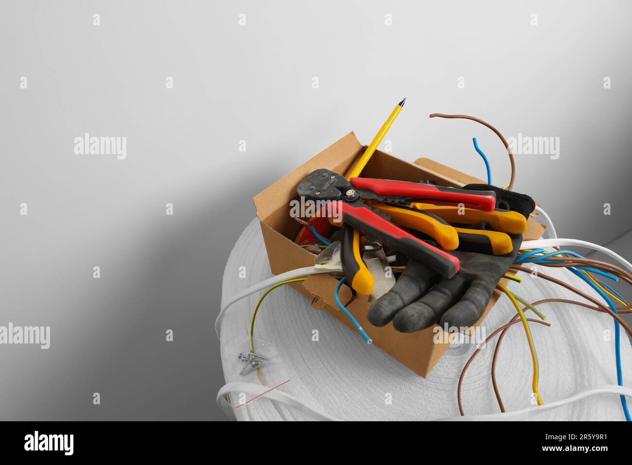 Different tools and cables in paper indoors. Installation of electrical ...