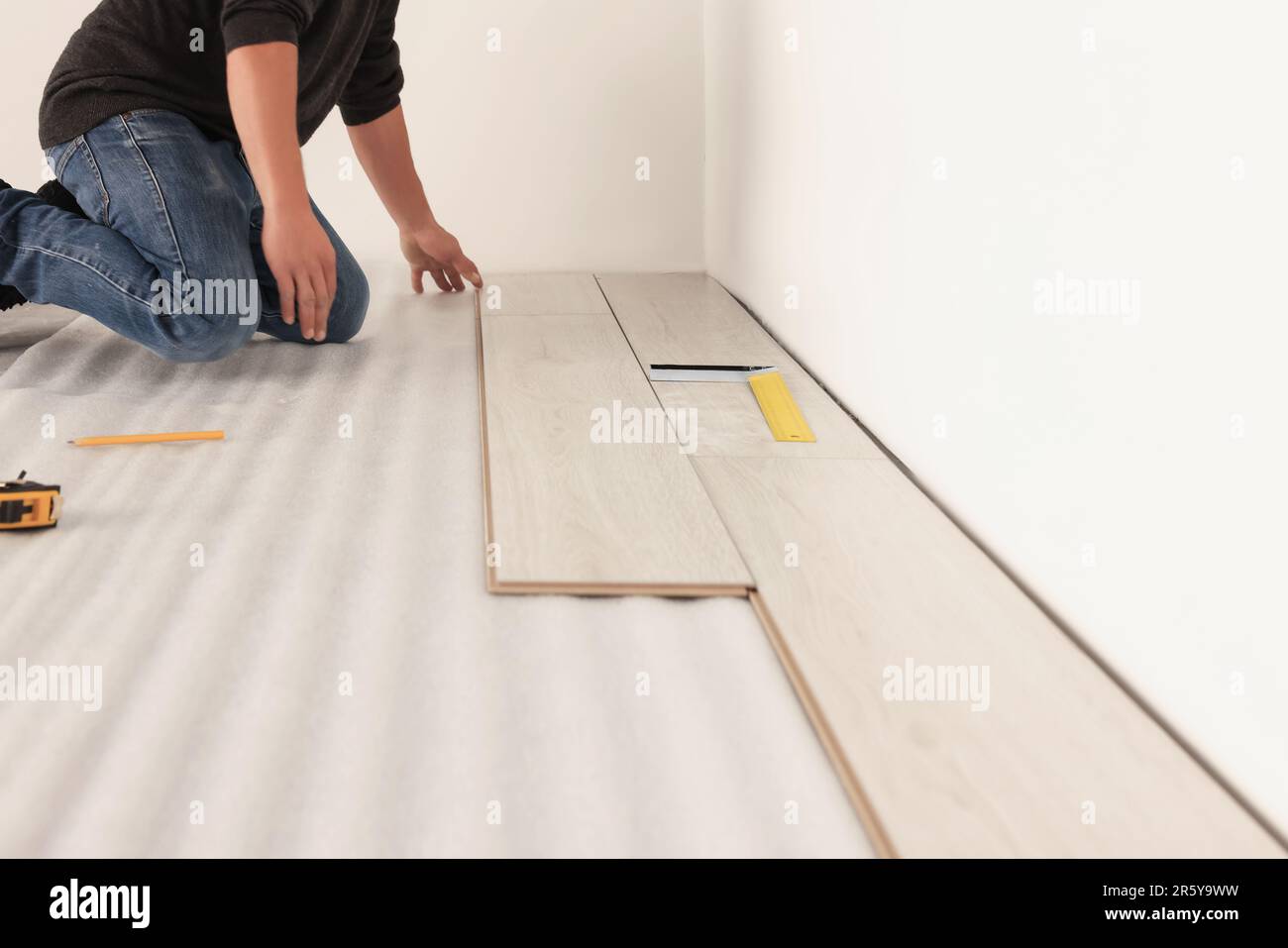 Professional worker installing new laminate flooring, closeup Stock Photo - Alamy