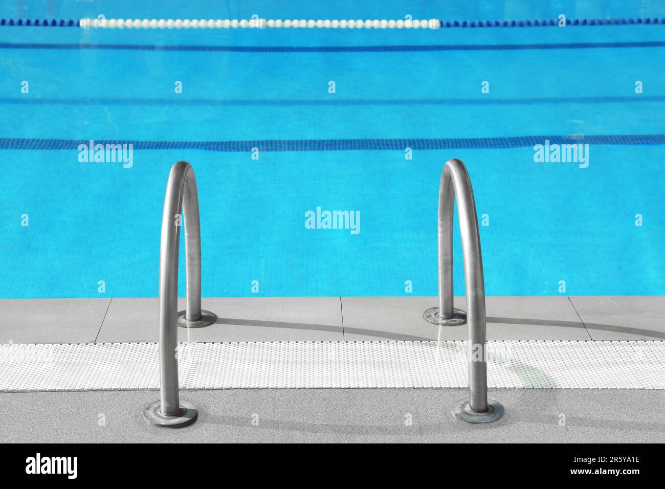 Ladder with handrails in outdoor swimming pool Stock Photo - Alamy
