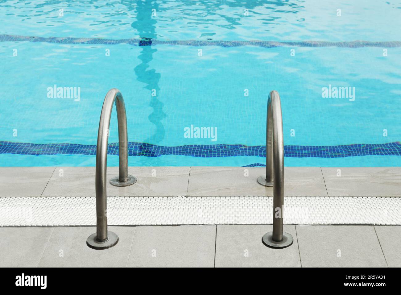 Ladder with handrails in outdoor swimming pool Stock Photo - Alamy