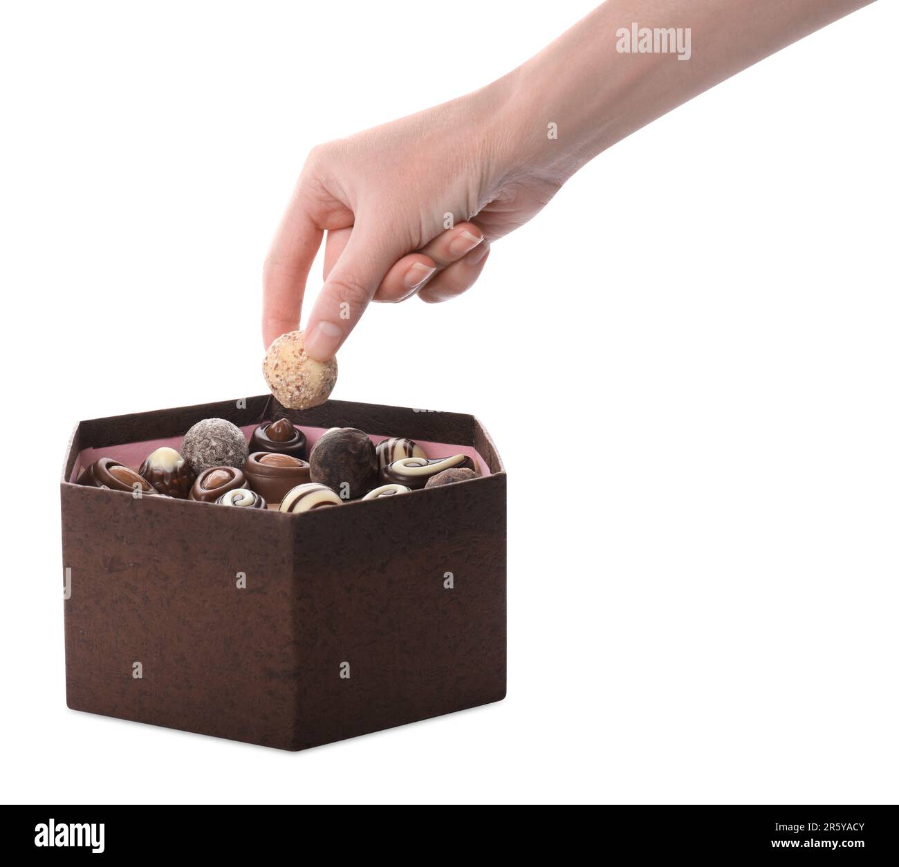 Woman taking chocolate candy out from box isolated on white, closeup ...