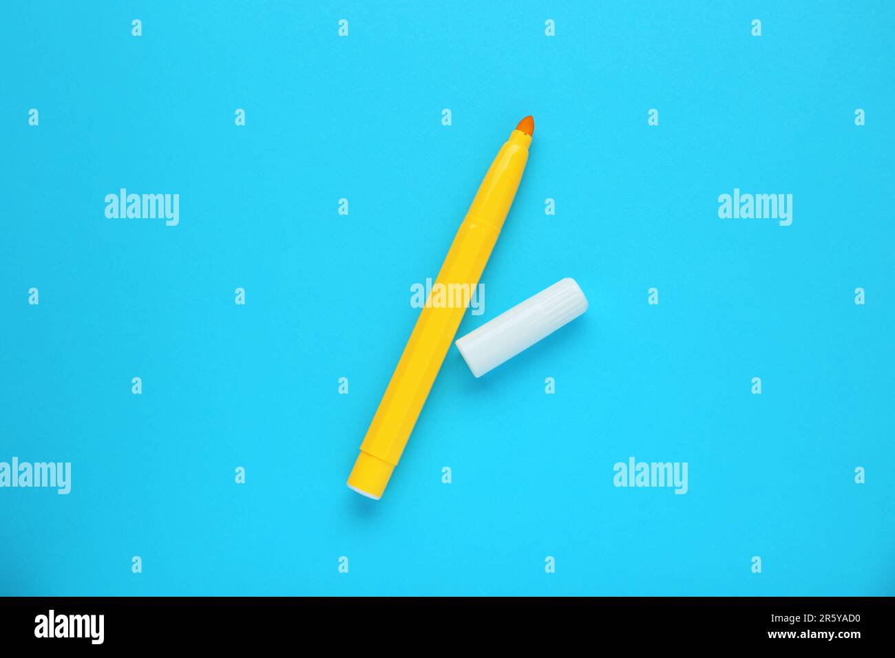 Bright yellow marker and cap on light blue background, flat lay Stock ...