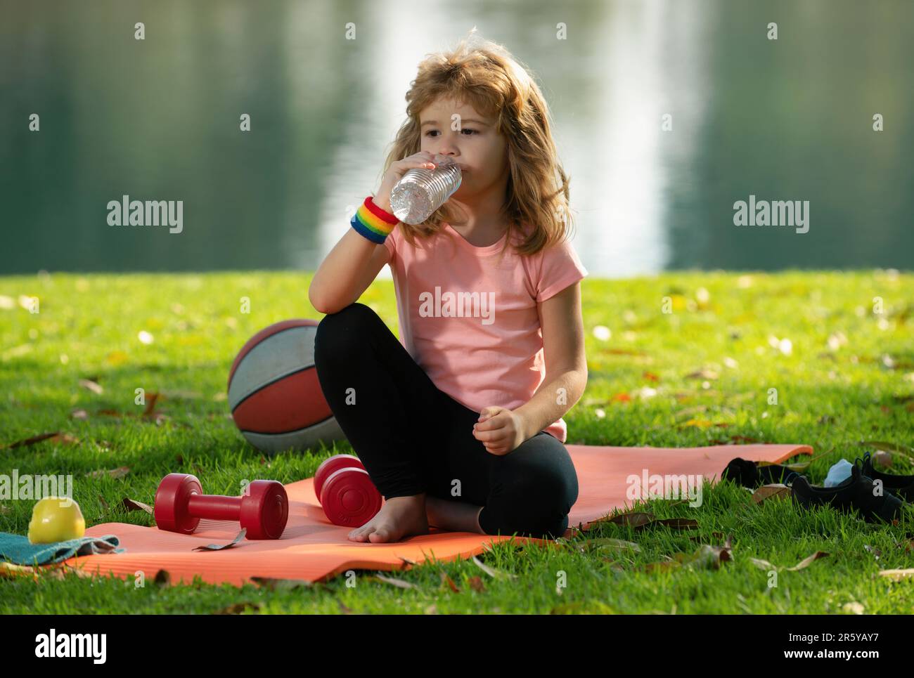 Child boy eating healthy food, drinking water after exercise. Fitness ...
