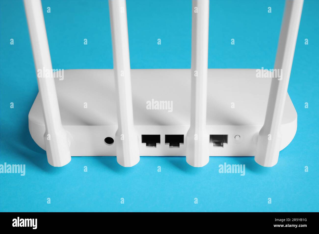 New white Wi-Fi router on blue background, back view Stock Photo - Alamy