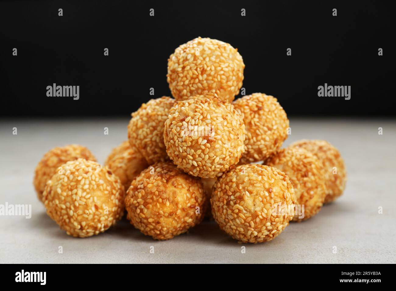 Many delicious sesame balls on textured table Stock Photo - Alamy