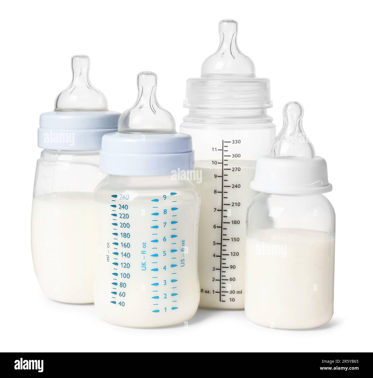 Many feeding bottles with infant formula on white background Stock ...
